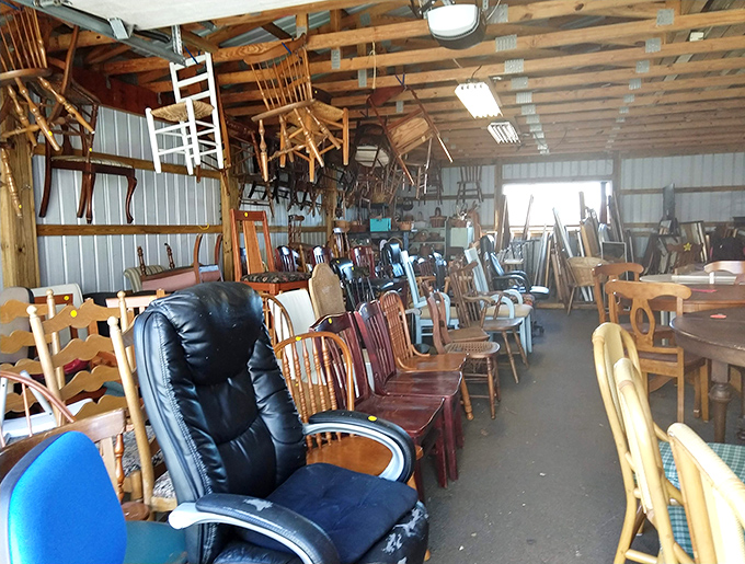 The furniture warehouse resembles a wooden chair convention, where office chairs and dining sets compete for the title of "Most Comfortable Steal."