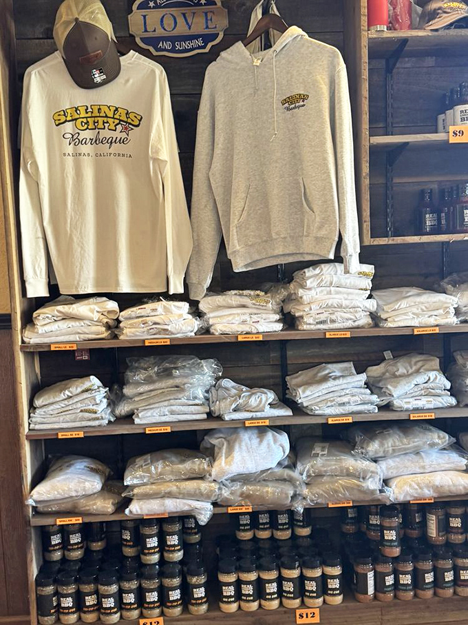 The merch wall says what everyone's thinking: "I came for the brisket but want the t-shirt to prove it."