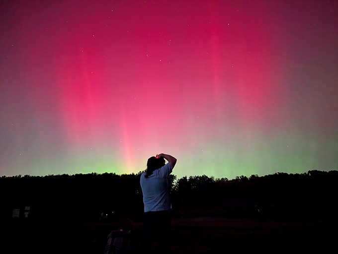 Ohio's unexpected light show! The rare appearance of the Northern Lights transforms Stonelick's night sky into a cosmic dance floor of pink and green.