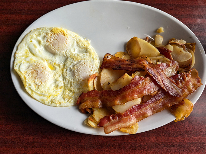 Bacon that's achieved that mythical balance between crisp and chewy. Those sunny-side-up eggs are basically morning sunshine on a plate.