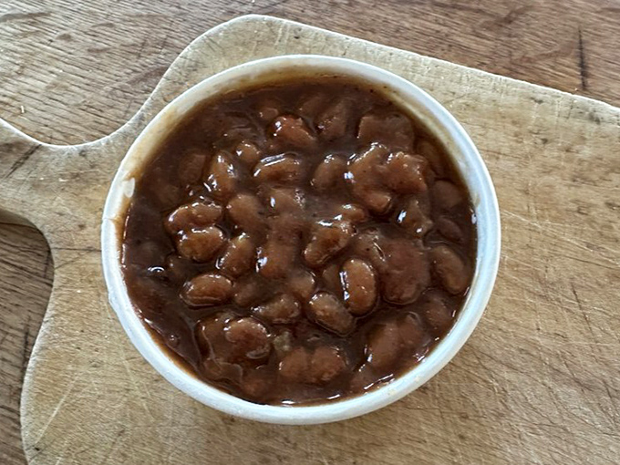 These aren't just baked beans—they're tiny legume submarines navigating through a sea of sweet-savory barbecue-infused sauce. Dive in.