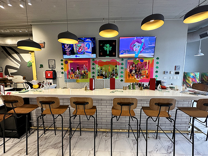 The bar area pops with colorful personality&mdash;where craft cocktails meet small-town charm under the warm glow of pendant lighting.
