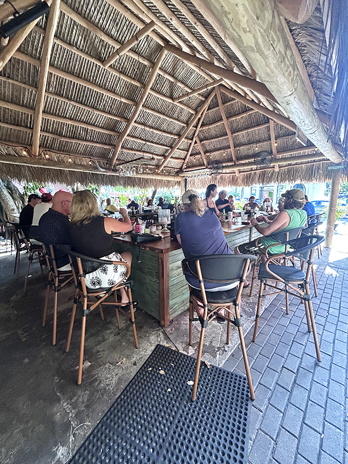 Thatched roof, tropical breeze, and tables full of happy diners. It's like someone bottled the concept of vacation and turned it into a dining space.