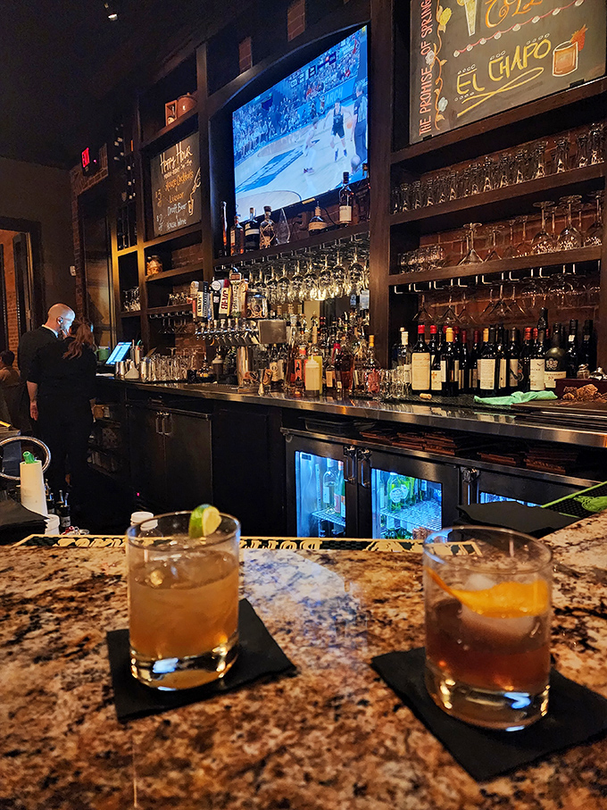 The well-stocked bar promises liquid adventures while the game plays quietly overhead. Civilization reached its peak right here.