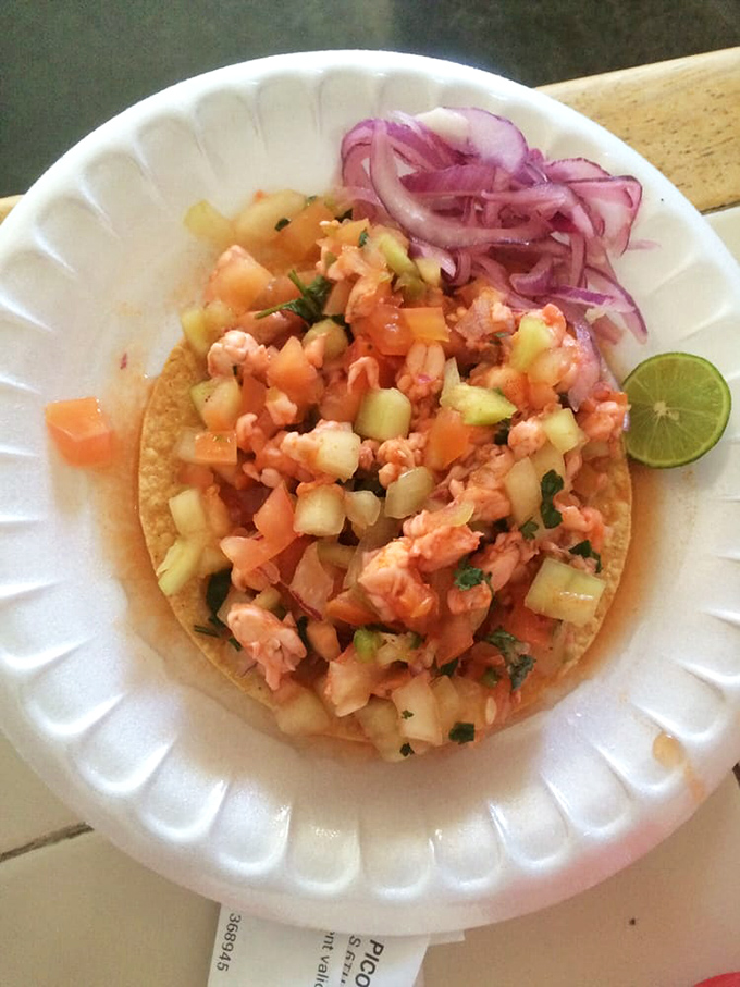 A seafood tostada that brings the Pacific Ocean to the Arizona desert, topped with a crown of pickled red onions.