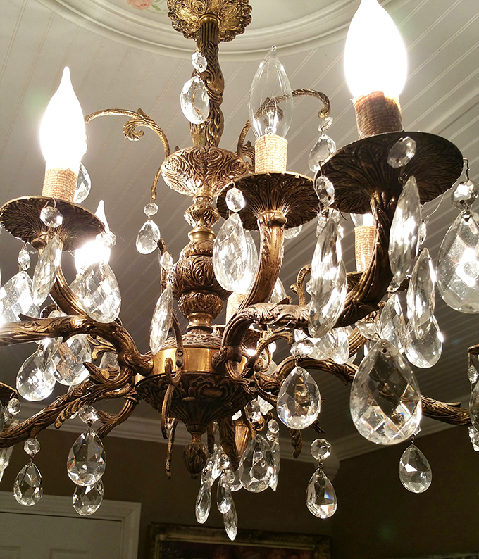 Chandelier royalty awaiting its next palace. This crystal masterpiece probably illuminated countless dinner parties before landing in thrift store limbo.