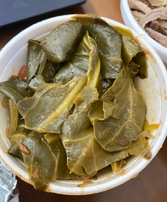 Collard greens cooked with the kind of patience and care that transforms humble vegetables into soul food.