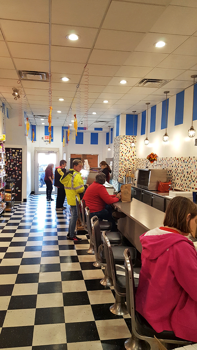 The soda fountain counter, complete with classic swivel stools, where ice cream dreams come true and craft soda floats reach their full potential.