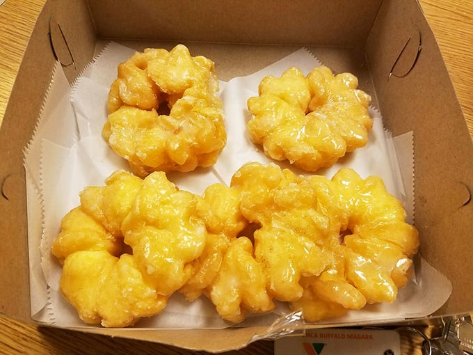 These golden cruller donuts practically glow in their box, their ridged exteriors promising the perfect balance of crunch and softness.
