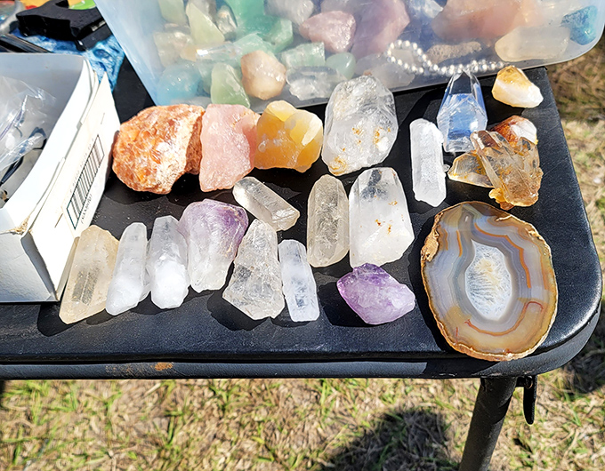 Nature's jewelry box spilled across black velvet. These crystals and geodes once formed deep within the earth, now destined for someone's meditation altar or windowsill.