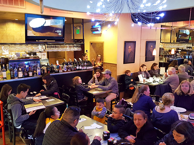 The dining room buzzes with the universal language of dessert appreciation&mdash;families and friends united in sweet communion.