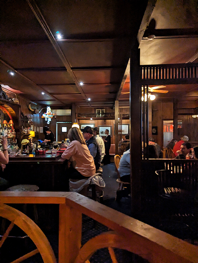 The bar area buzzes with conversation and clinking glasses, where locals and tourists alike gather to share stories and steaks under the warm glow of Western hospitality.