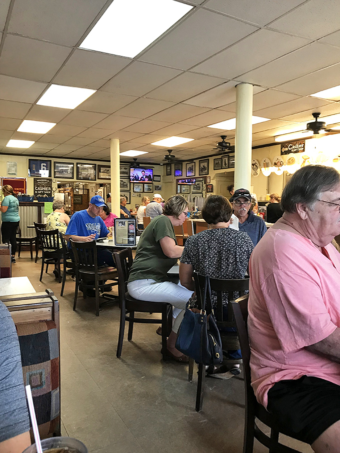 The dining room buzzes with conversation and clinking plates. Here, strangers become friends over shared tables and racing memories.