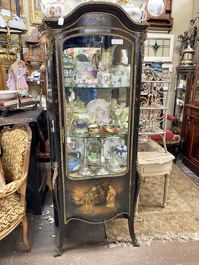 This curvaceous antique vitrine cabinet doesn't just display fine china&mdash;it elevates it to museum status. Victorian elegance with a French accent.