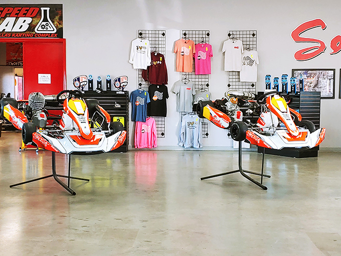 Racing karts on display – like exotic animals in a high-octane zoo where "please don't touch" signs are routinely ignored.