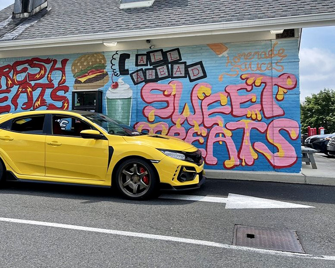 The colorful mural featuring burgers and shakes serves as a siren call to hungry drivers. Resistance is futile&mdash;and why would you even try?