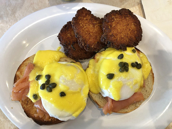 Eggs Benedict with lox—breakfast elevated to an art form. Those potato latkes on the side aren't just garnish; they're co-stars in this morning drama.
