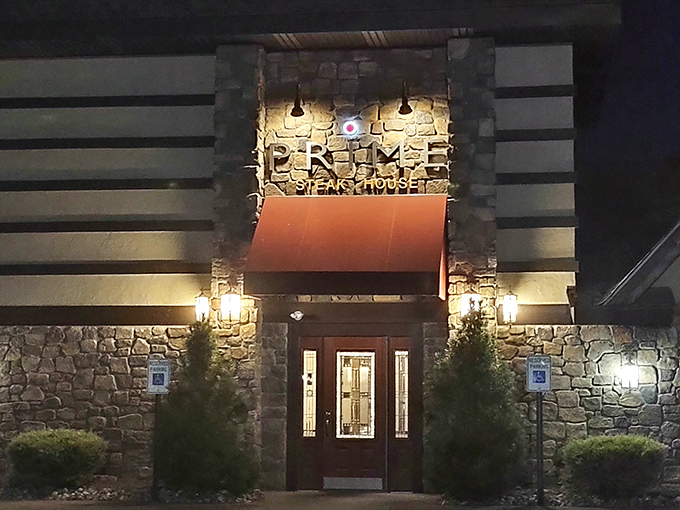 As evening falls, the illuminated entrance transforms into a beacon for the hungry, promising warmth and satisfaction just beyond those doors.