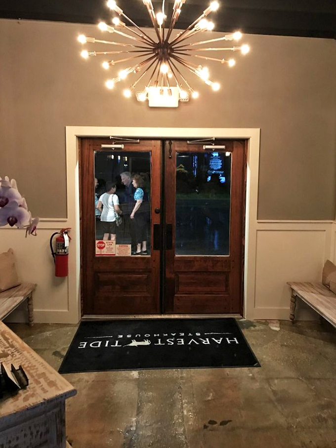 The entrance sets the tone with its starburst chandelier and wooden doors&mdash;like crossing the threshold into a world where everyday concerns take a back seat to culinary pleasure.
