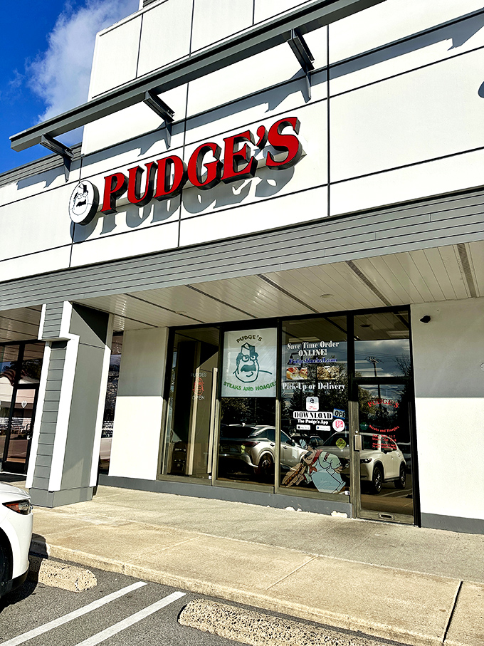 Blue skies and red letters &ndash; a perfect Pennsylvania day begins with Pudge's. The entrance promises satisfaction just steps away.