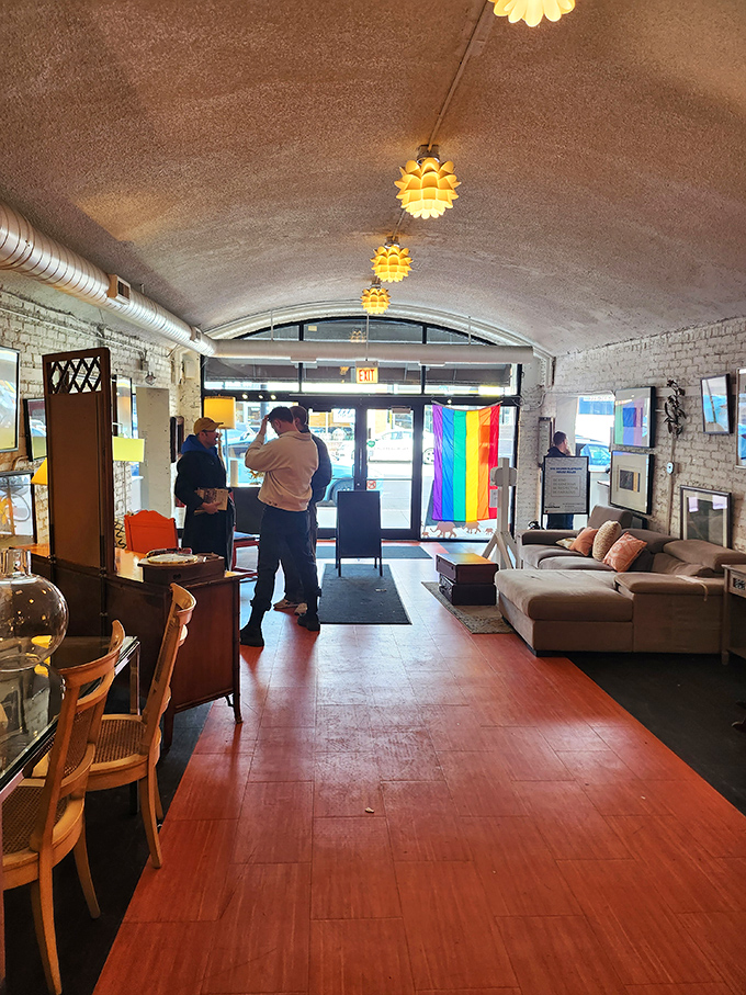 Sunlight streams through rainbow pride flags near the exit. Vintage pendant lights shaped like artichokes guide shoppers back to the real world, purchases in hand. 