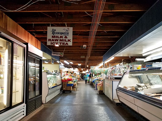 Market corridor cornucopia &ndash; refrigerated cases and family vendors create a gauntlet of temptation impossible to navigate without multiple purchases.