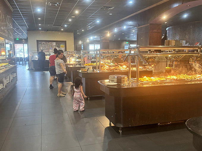 Families navigate the buffet stations with the careful strategy of generals planning battle campaigns &ndash; each member assigned to scout different culinary territories.