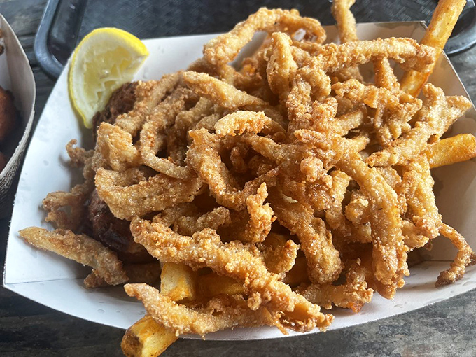 Fried clam strips piled high like a delicious game of Jenga. One wrong move and they'll tumble straight into your mouth&mdash;which was the plan all along.