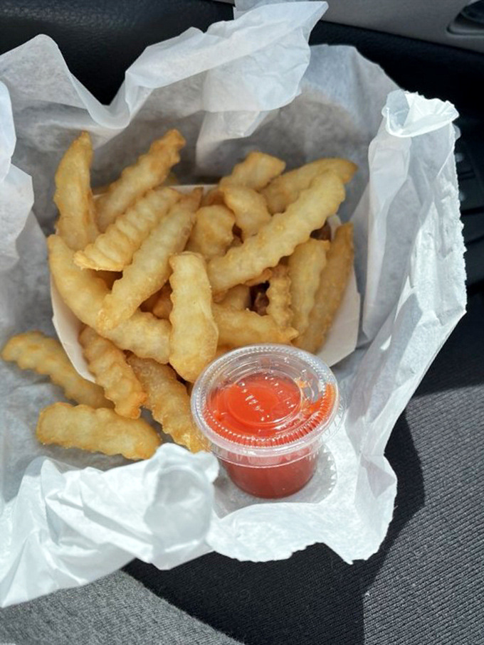 Crinkle-cut fries in paper&mdash;not served on a slate or in a miniature shopping cart, just honest potatoes done right.