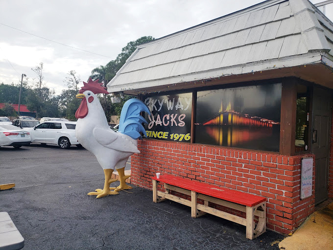 The rooster stands sentinel, guarding the entrance to egg paradise. This fiberglass fowl has witnessed thousands of breakfast pilgrimages.