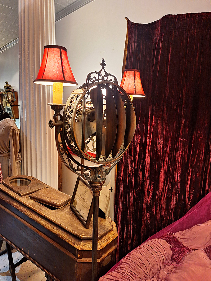 This ornate funeral lamp with its red shades cast a warm, flattering light&mdash;because even in the 19th century, good lighting was essential for life's final appearance.