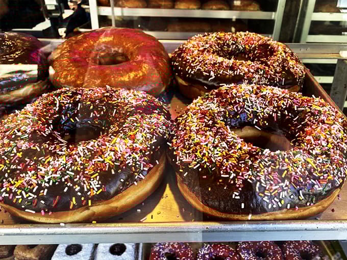 Giant chocolate donuts adorned with rainbow sprinkles remind us that sometimes bigger really is better.