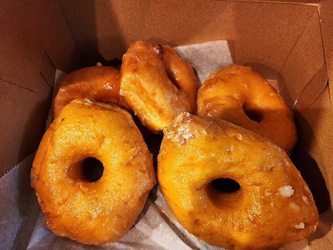Golden rings of happiness, boxed for your convenience. These glazed donuts have the perfect sugar-to-dough ratio&mdash;scientific proof that joy is edible.