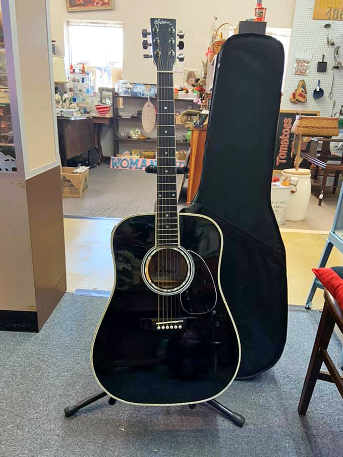 This gleaming black acoustic guitar isn't just an instrument – it's decades of unplayed melodies waiting for new fingers to bring them to life.
