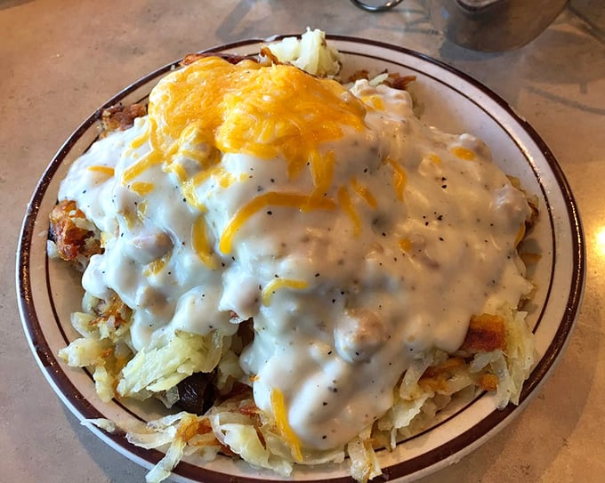Behold: hash browns smothered in country gravy and cheese&mdash;comfort food that hugs your soul from the inside out.