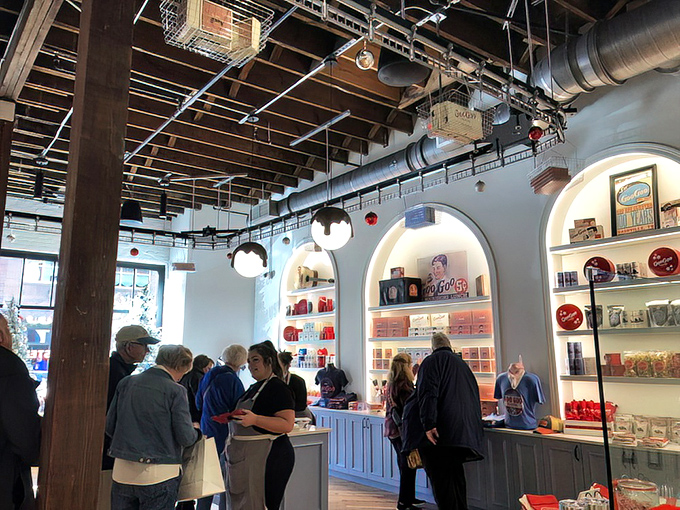 The arched display shelves showcase Goo Goo history and merchandise, drawing visitors like a chocolate museum where sampling is highly encouraged.