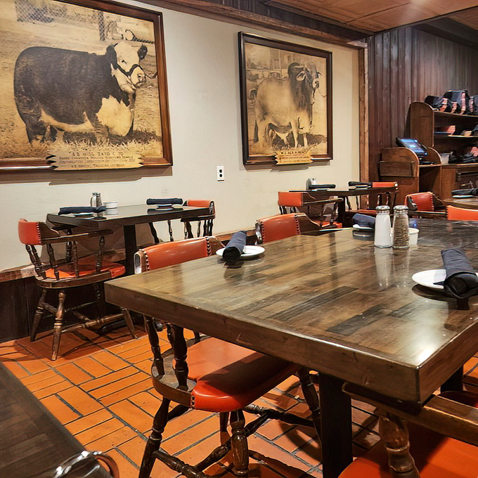 Wooden tables that have hosted everything from first dates to business deals, surrounded by vintage cattle portraits that silently approve.