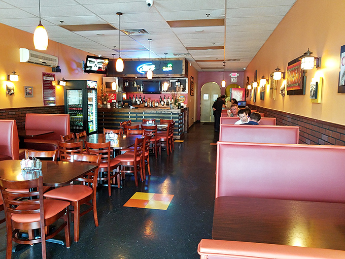 Cozy booths in warm tones invite lingering conversations over shared plates. The perfect setting for turning dinner into an event.