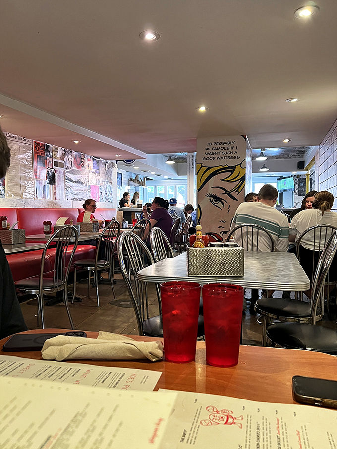 Red booths and pop art create the perfect backdrop for breakfast therapy. That comic-style wall art speaks the universal truth of morning-after dining.