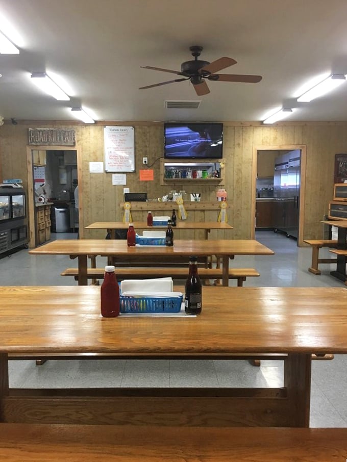 Simple surroundings let the food take center stage. Red ketchup bottles stand ready for duty at each picnic-style table.