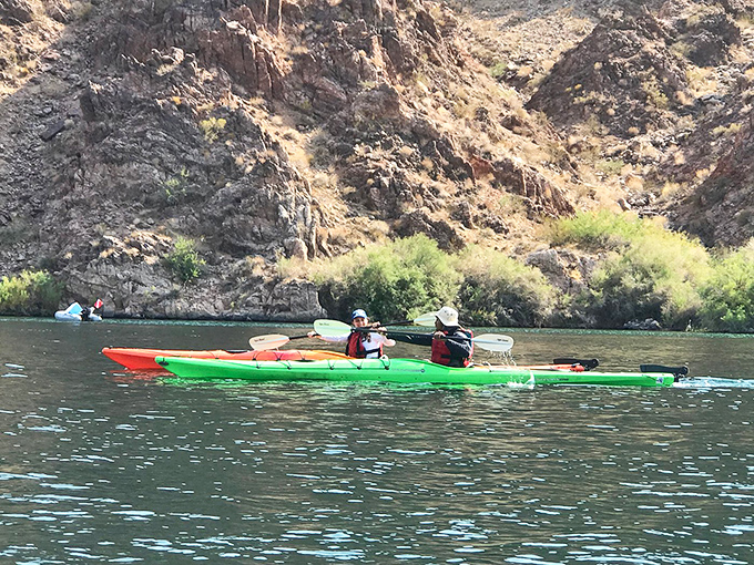 Kayakers finding their rhythm in emerald waters, proving paradise doesn't always require a passport or coconut drinks.
