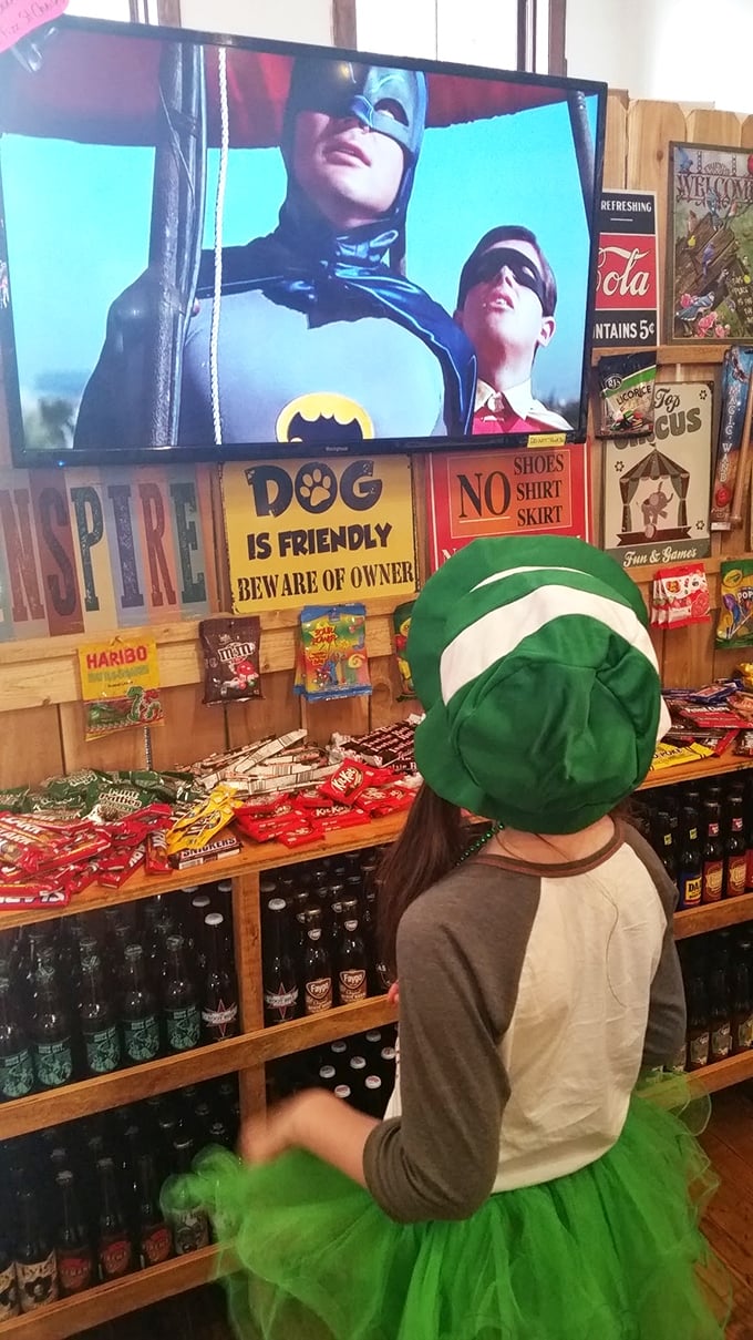 Even Batman and Robin pause their crime-fighting to appreciate Rocket Fizz's selection, while signs remind visitors that dogs are welcome but shoes are mandatory.