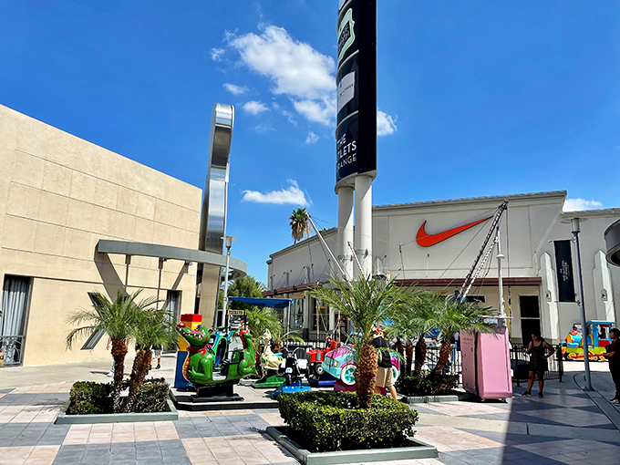 Colorful kiddie rides provide the perfect distraction while parents contemplate their next clothing purchase decision.