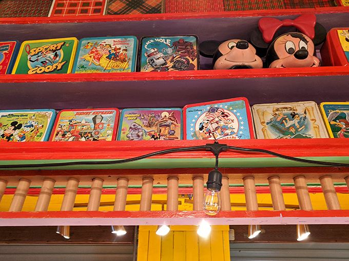 Mickey and Minnie watch over a rainbow of vintage lunchboxes, proving Disney's merchandising magic has been capturing kids' hearts for generations.
