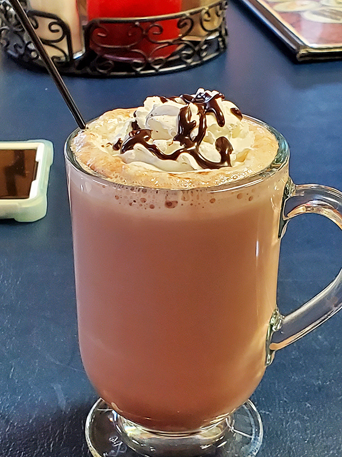 This isn't just hot chocolate&mdash;it's liquid comfort topped with a cloud of whipped cream. The chocolate drizzle is just showing off at this point.