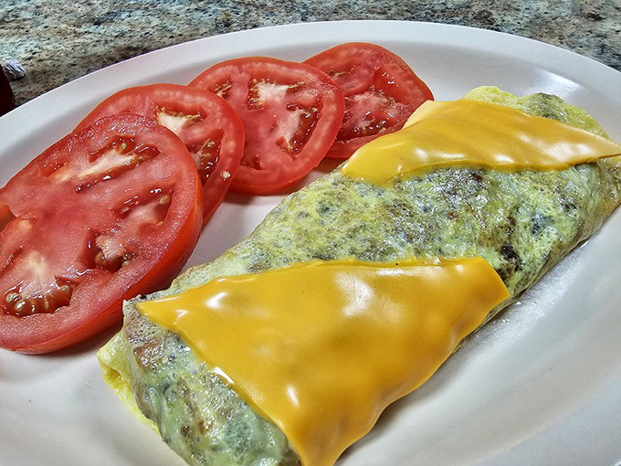 An omelet that's achieved perfect cheese-melt status, paired with fresh tomatoes for that hint of virtue we all need with our indulgences.