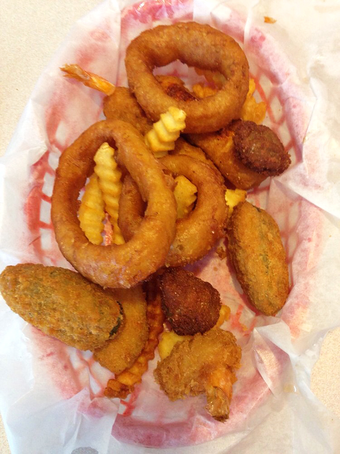 Golden-fried onion rings and assorted fried treasures—proof that sometimes the best things in life come in a paper basket lined with nostalgia.