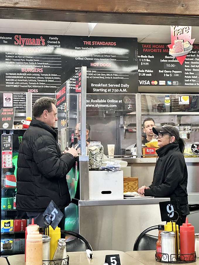 The ordering counter: where hope begins and diet plans go to die. Make eye contact, speak clearly, and prepare for greatness.