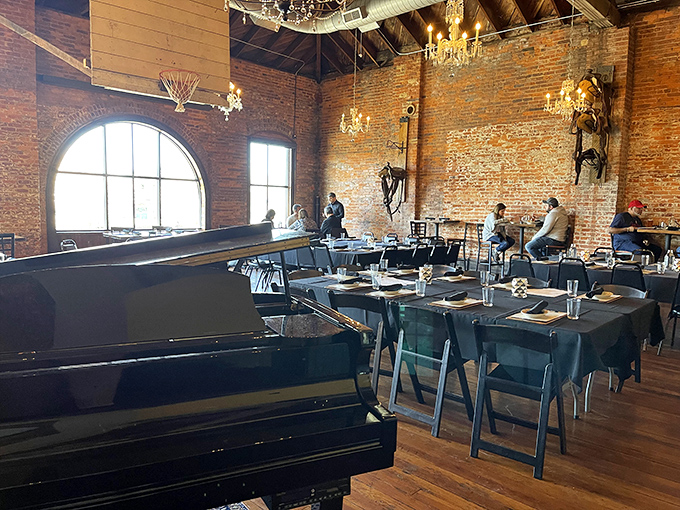 The grand piano stands ready to provide the soundtrack to your meal, while those arched windows frame the outside world you've temporarily forgotten.