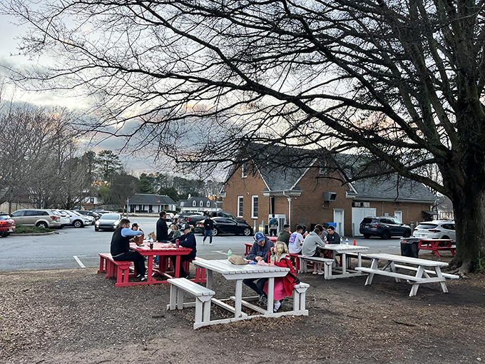 Al fresco dining, gas station style. These picnic tables might lack white linen, but they've hosted more genuine food joy than many Michelin-starred establishments.